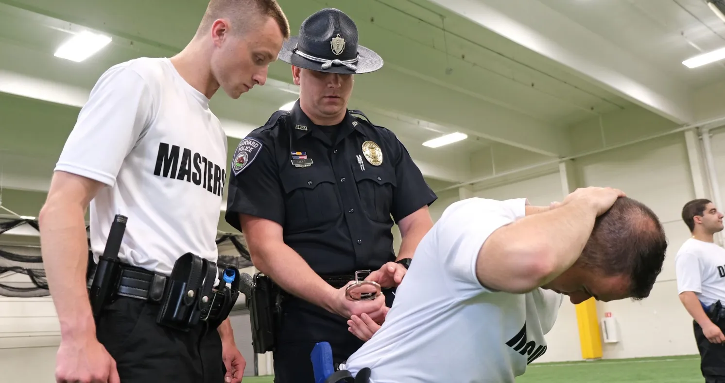 Police Academy students working on handcuffing | Fitchburg State University