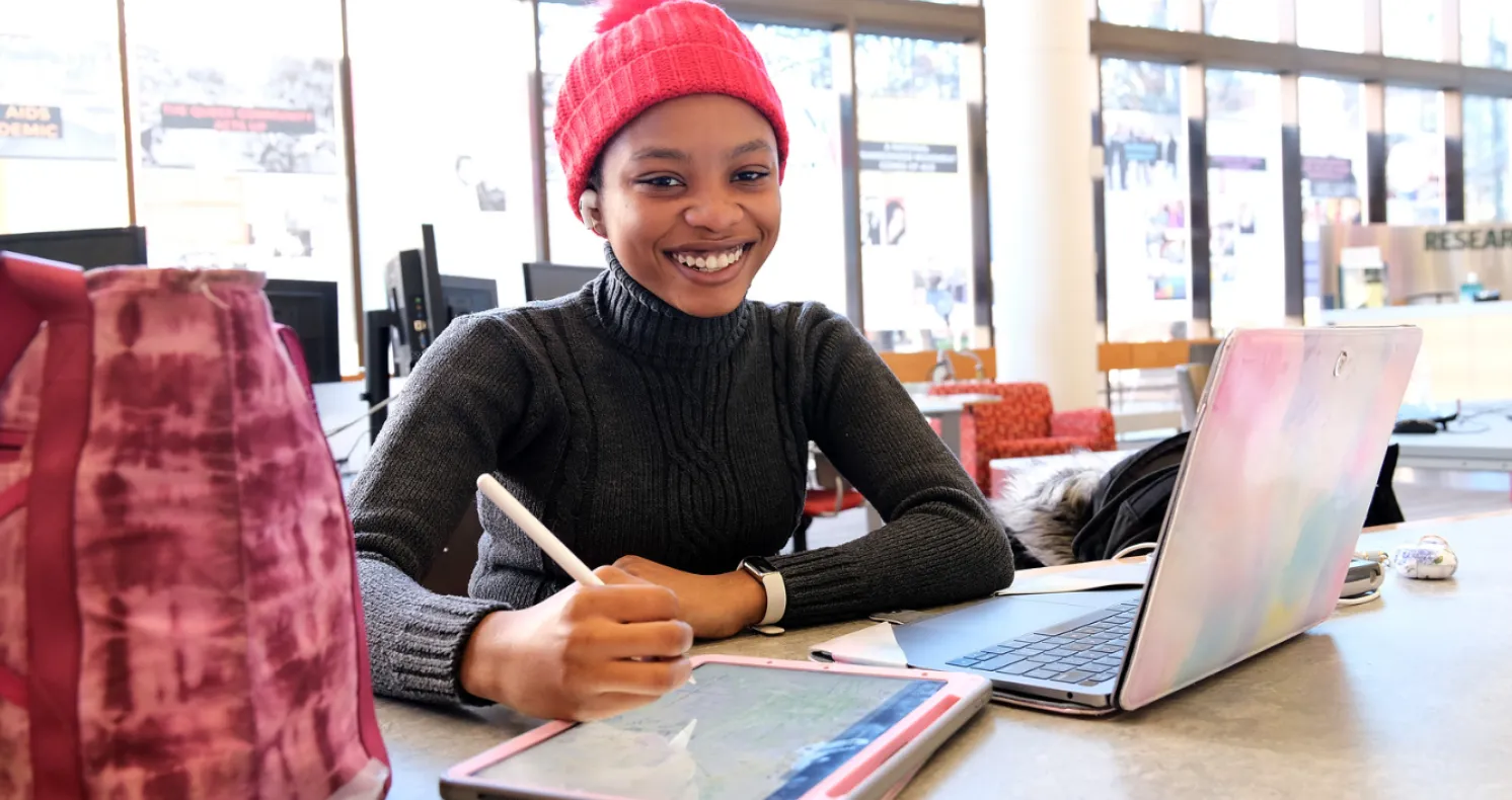 Student in library | Fitchburg State University